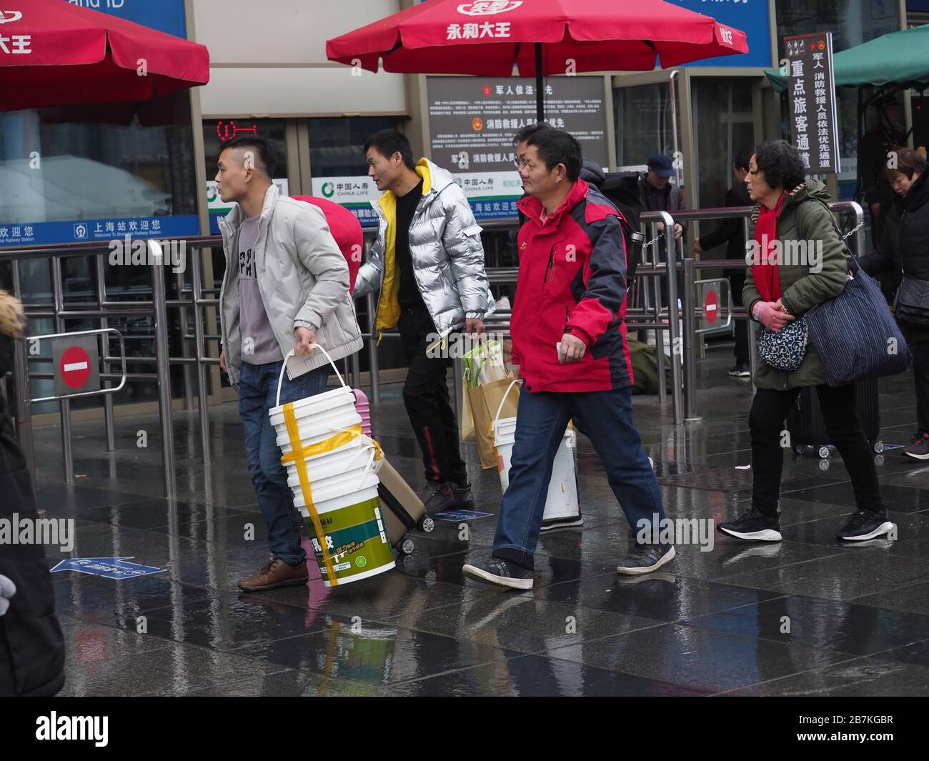 --File--Migrant workers carry luggages at the Shanghai New Bus Terminal ...
