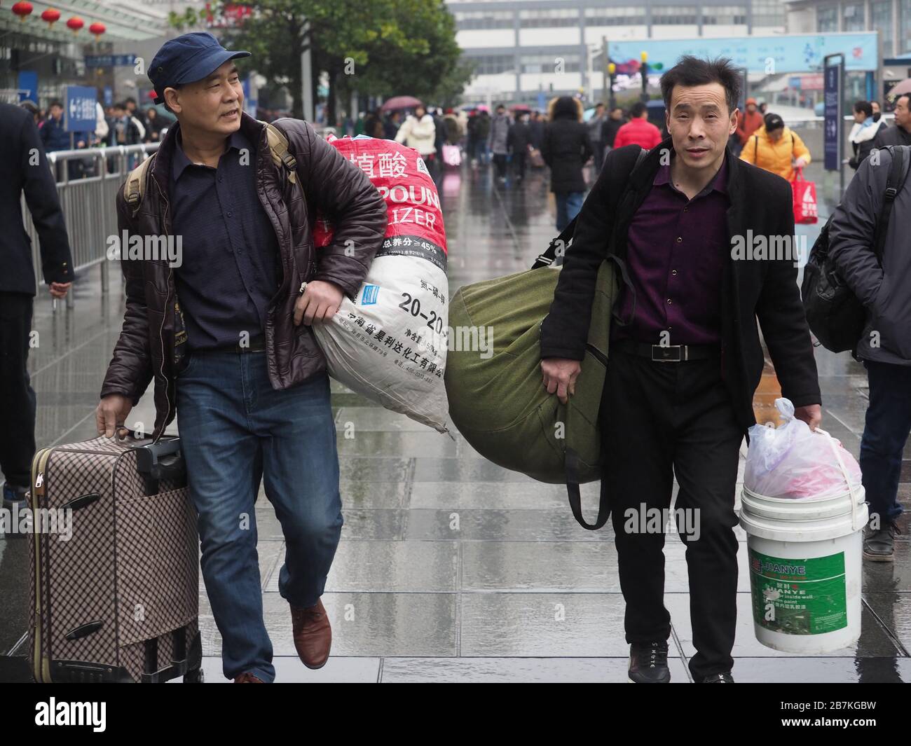 --File--Migrant workers carry luggages at the Shanghai New Bus Terminal ...
