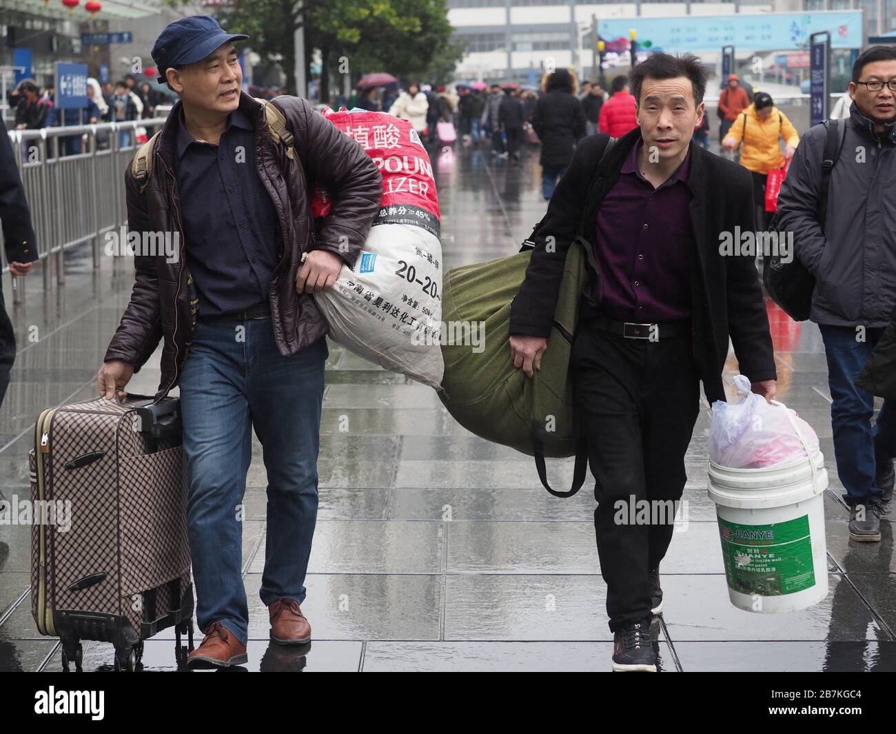 --File--Migrant workers carry luggages at the Shanghai New Bus Terminal ...