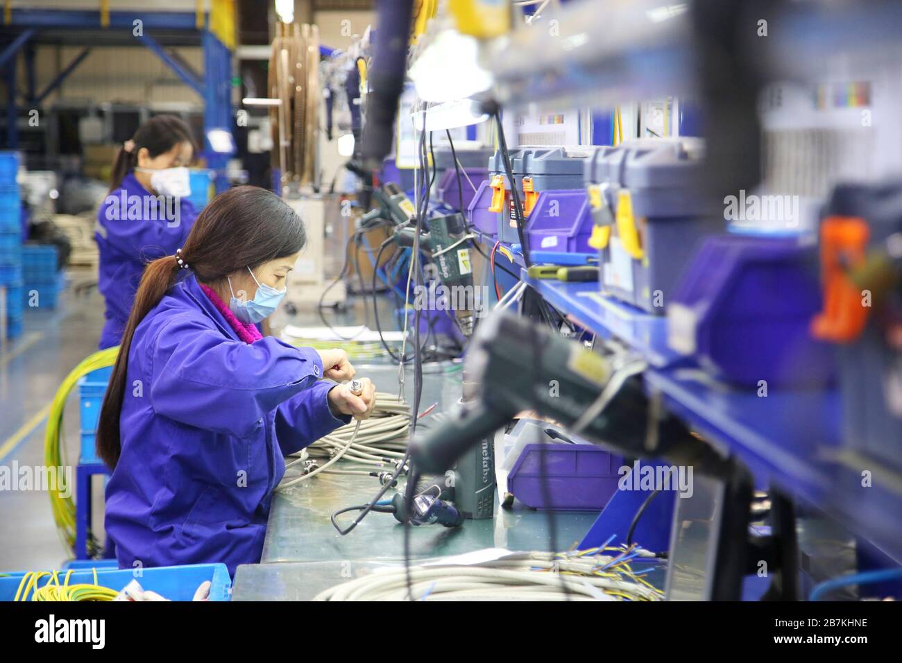 Factory workers work in a plant in Changzhou city, east China's Jiangsu ...