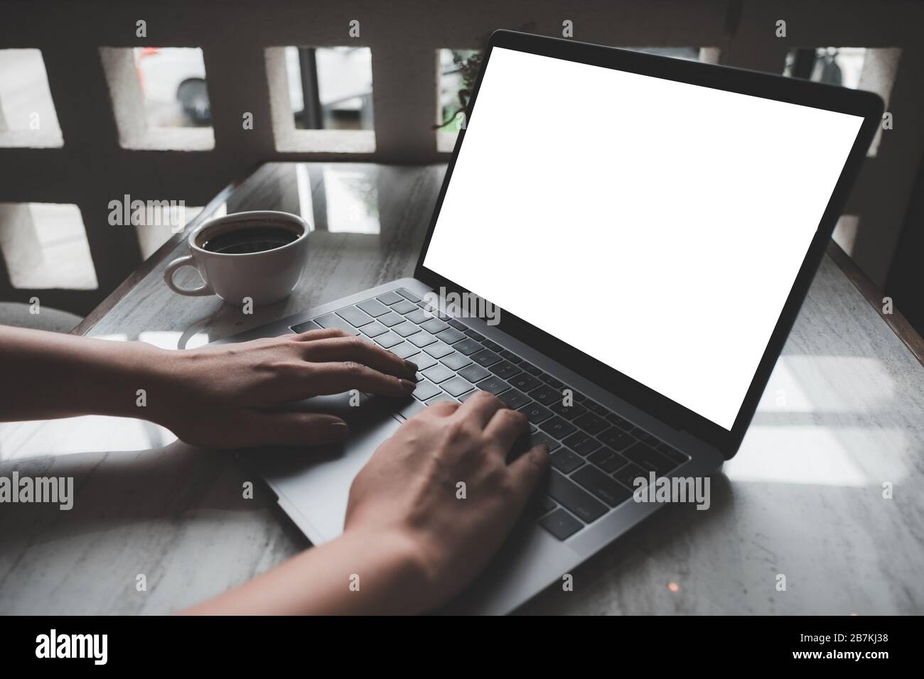 Mockup image of a woman using and typing on laptop with blank white ...