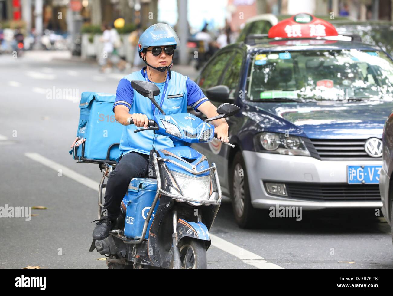 --FILE--Deliverymen from different platforms offering online food order ...