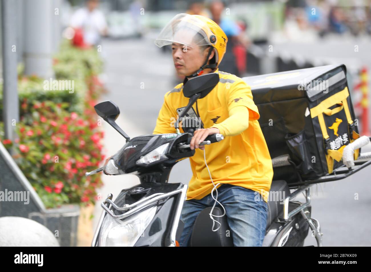 --FILE--Deliverymen from different platforms offering online food order ...