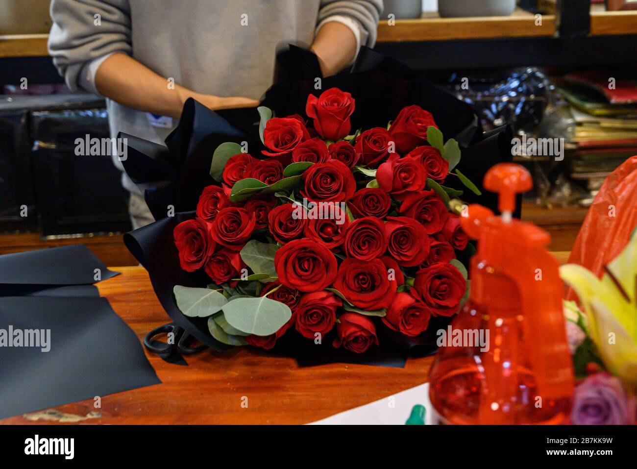 Staff arrange flowers at a flower shop in Guangzhou city, south China's ...