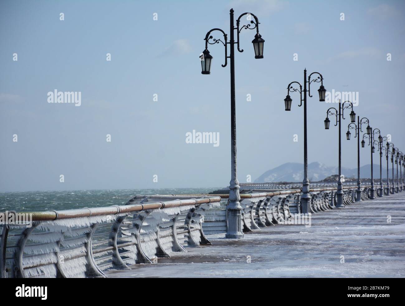 Due to gale and low temperature, ice appears and is hung at handrail at ...