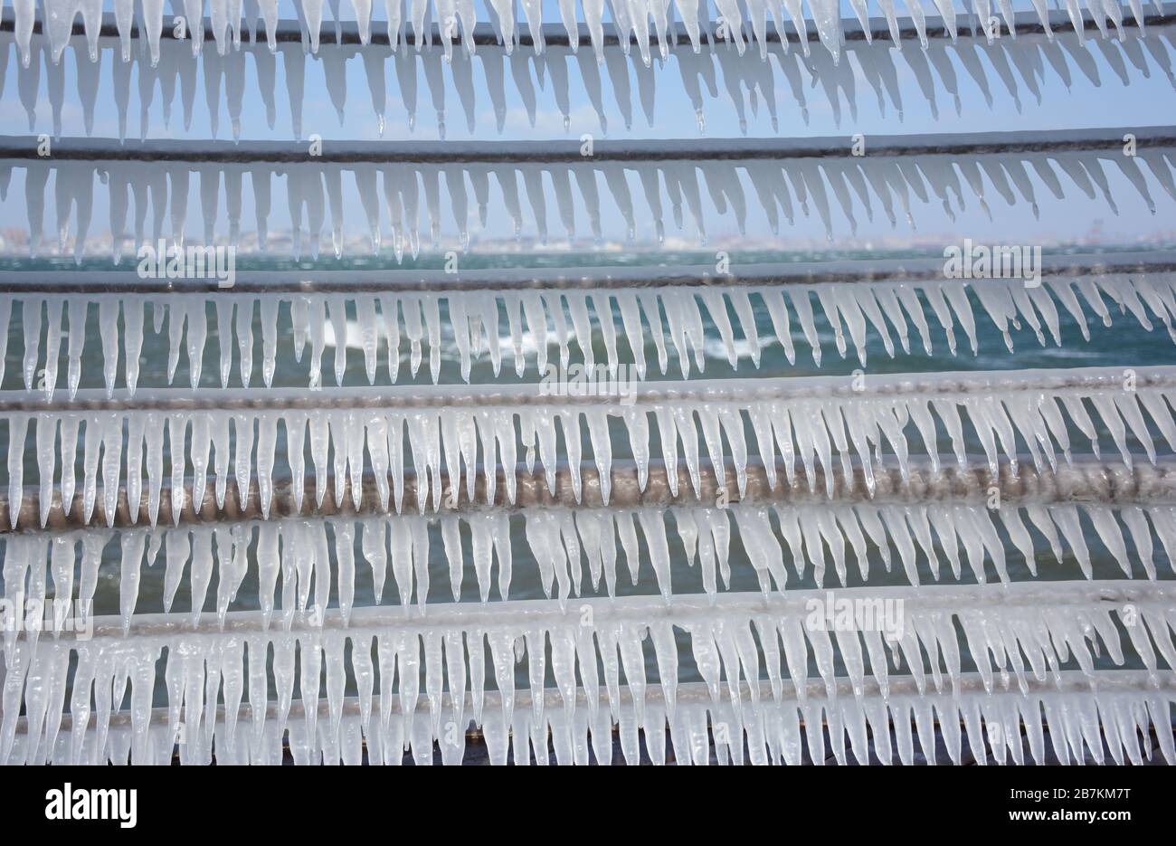 Due to gale and low temperature, ice appears and is hung at handrail at ...