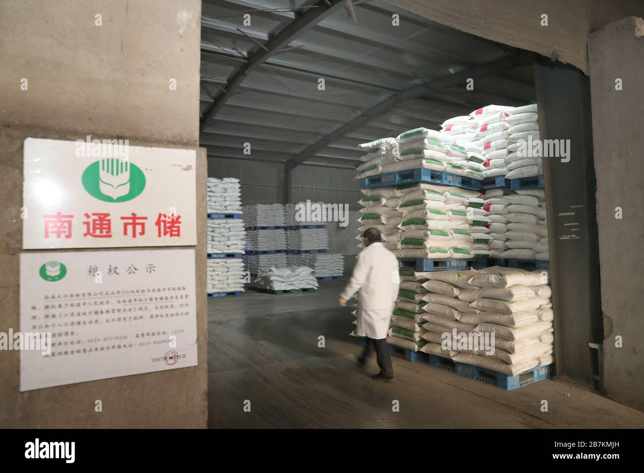 Bags of flour are stored at a warehouse of a flourmill with a long ...