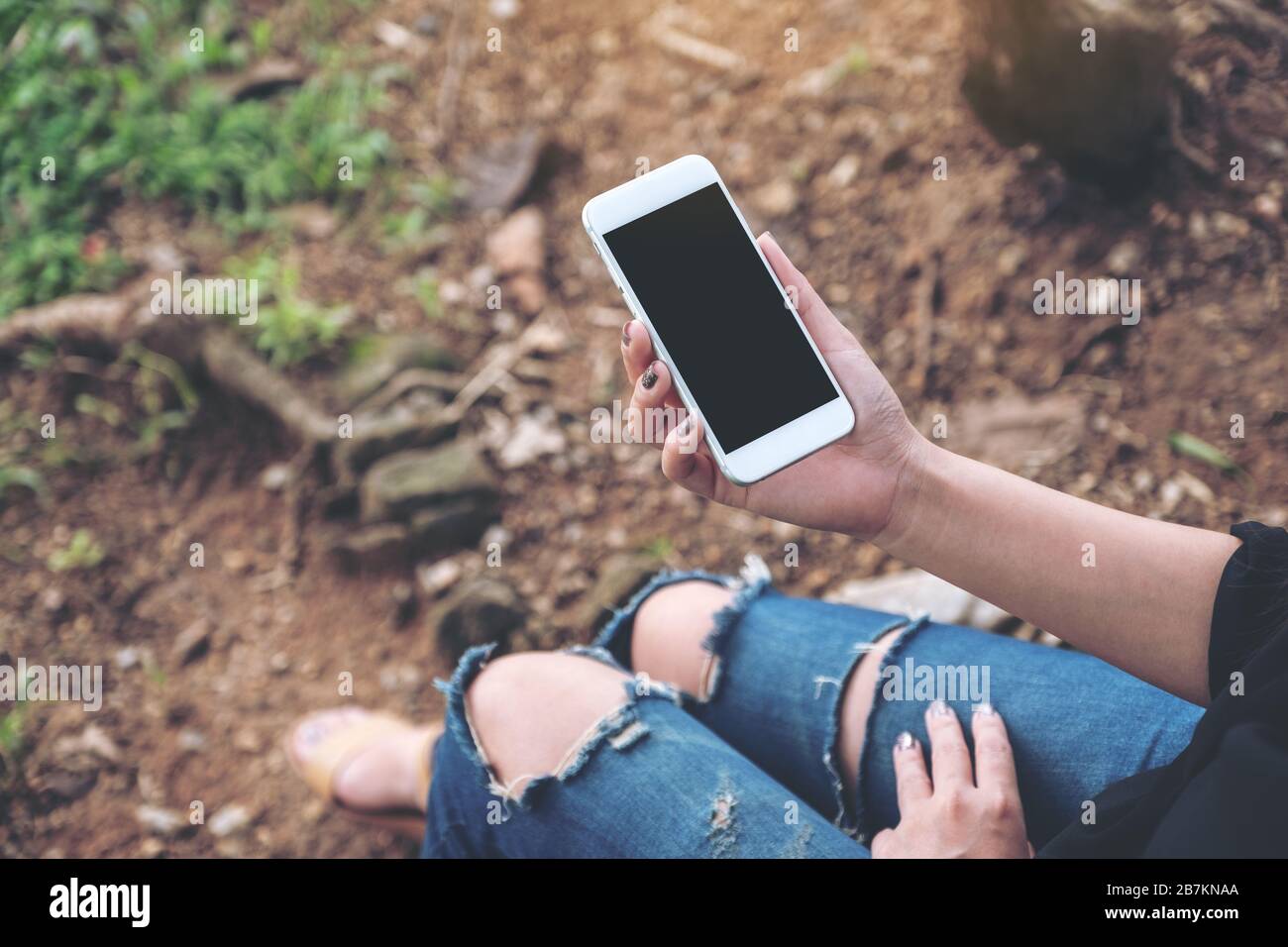 Mockup image of woman holding white mobile phone with blank desktop ...