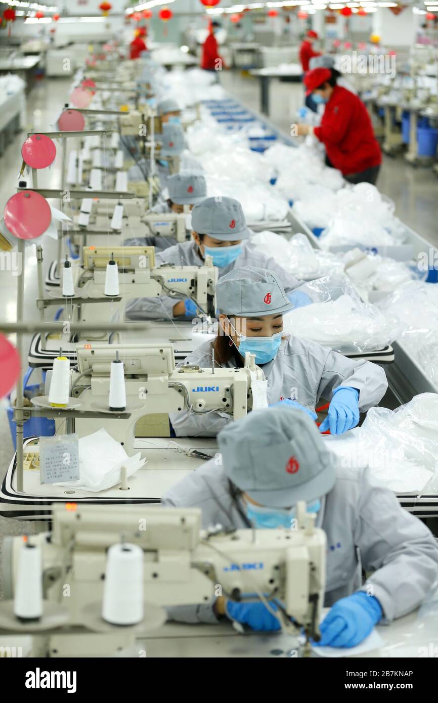 Staff of a spinning mill are busy at producing masks to meet the ...