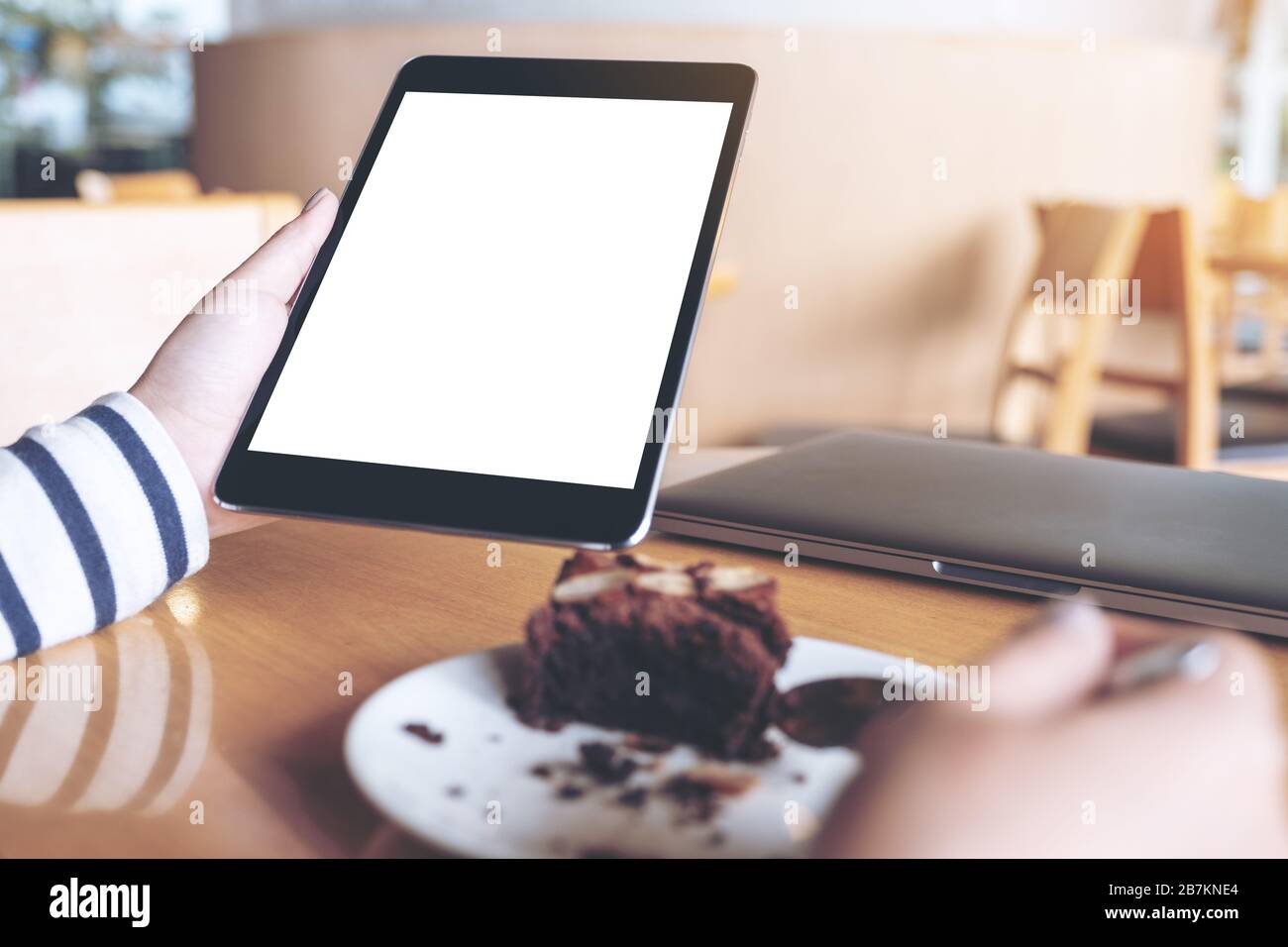 Mockup image of woman holding black tablet pc with blank white desktop ...