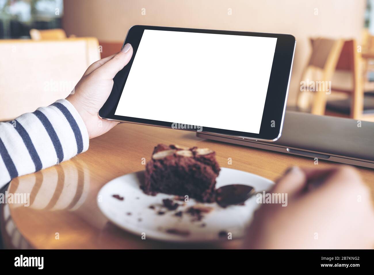 Mockup image of woman holding black tablet pc with blank white desktop ...