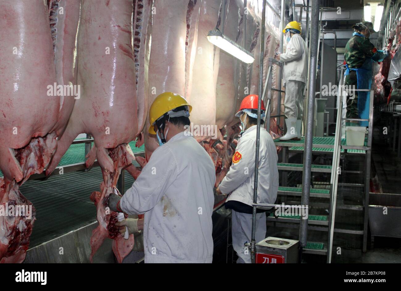 Staff of a food processing factory owned by Shuanghui Group, a China ...