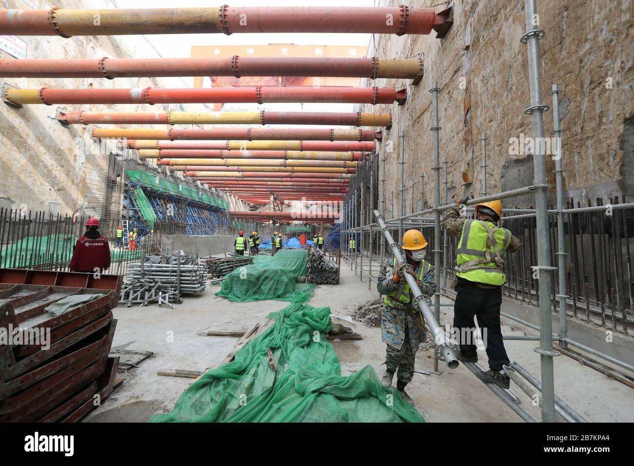 Workers restart to construct an extended subway line at the ...