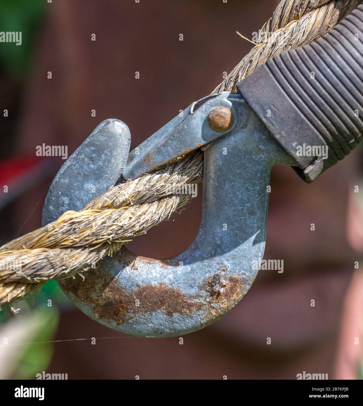 A metal hook isolated attached to a tick rope conceptual image Stock ...