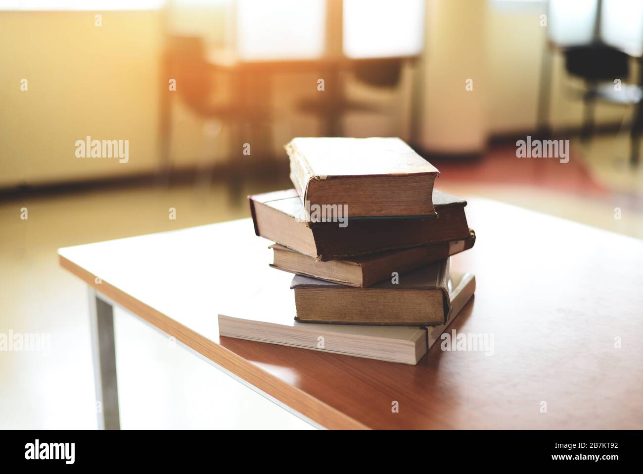 Books on the table in the library / Education learning book stack on ...