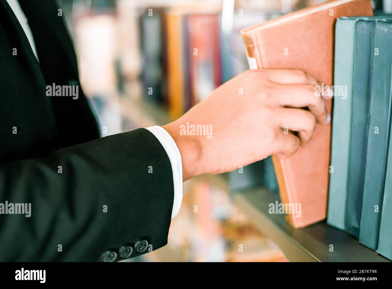 Business man or student holding a book on hand or Picking a book on ...