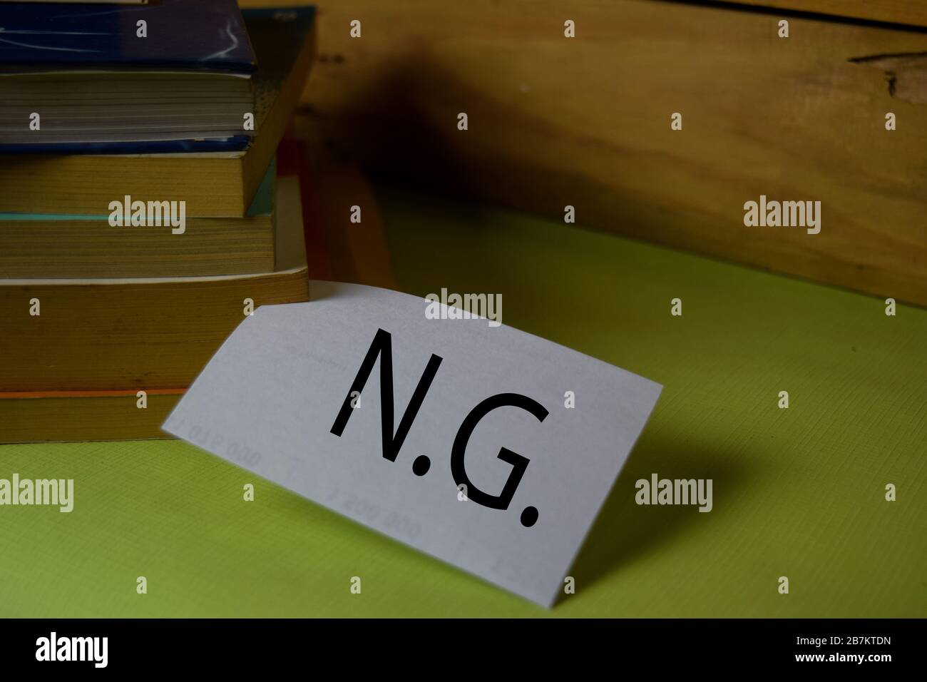 NG write on a sticky note isolated on Office Desk. Business Document ...