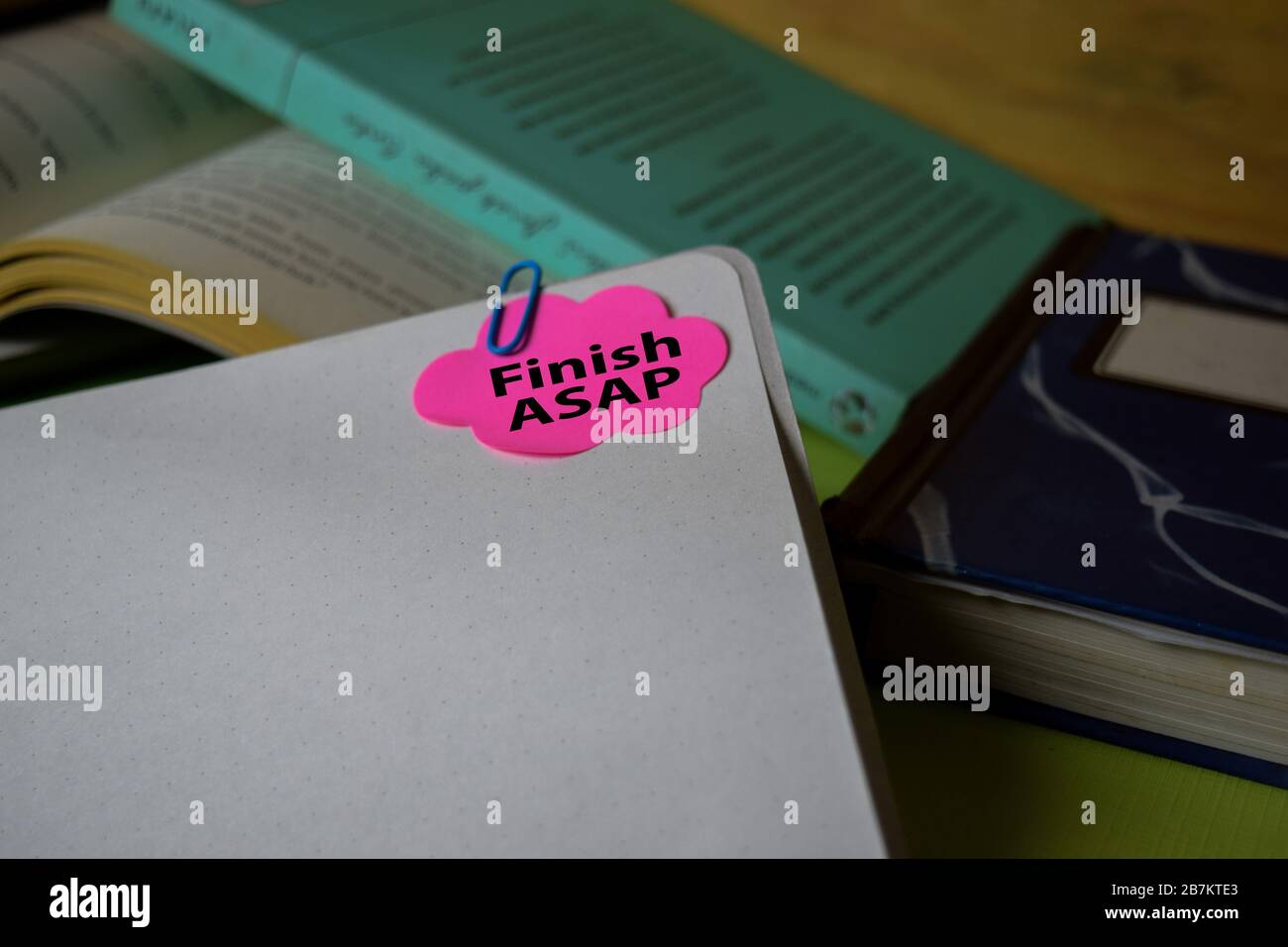 Finish ASAP write on a sticky note isolated on Office Desk. Business ...