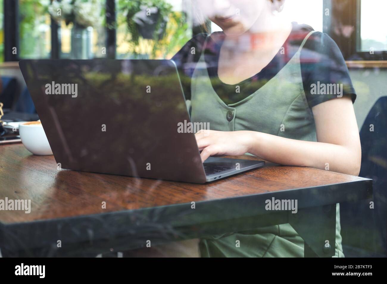 Closeup image of a business woman's hands working and typing on laptop ...