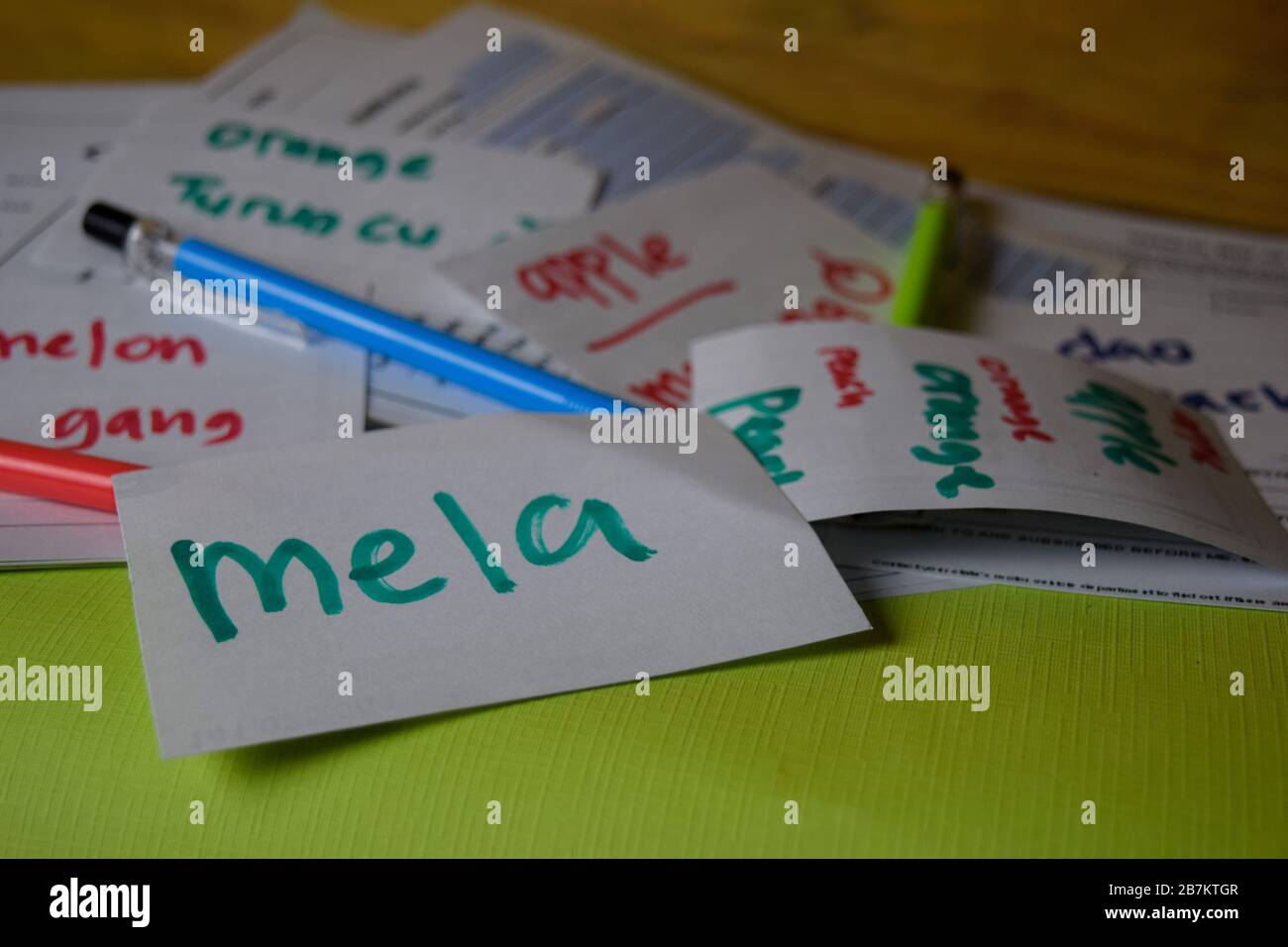 Mela write on a sticky note its mean apple isolated on Office Desk ...