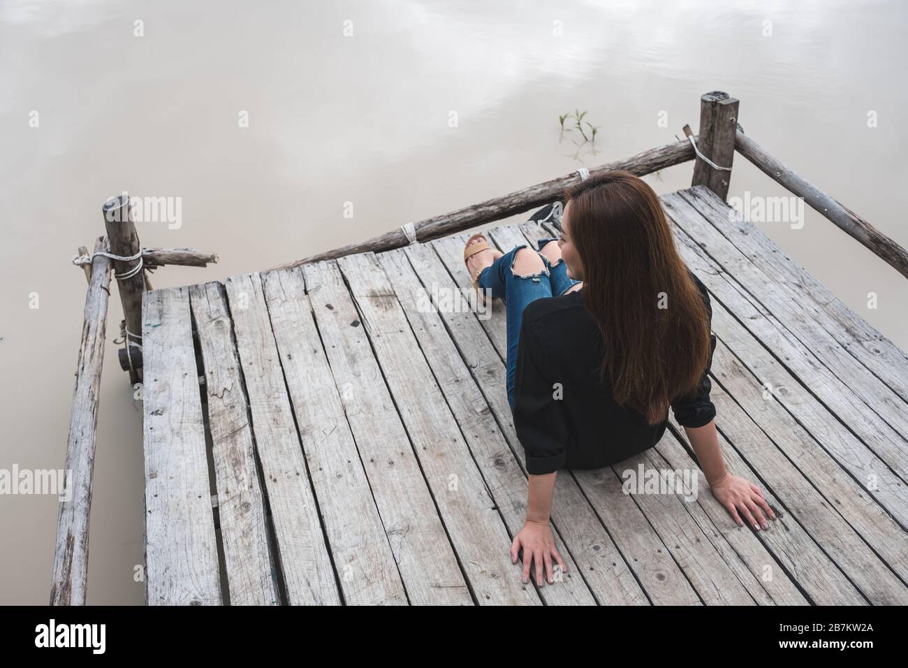 Top view woman sitting on dock hi-res stock photography and images - Alamy
