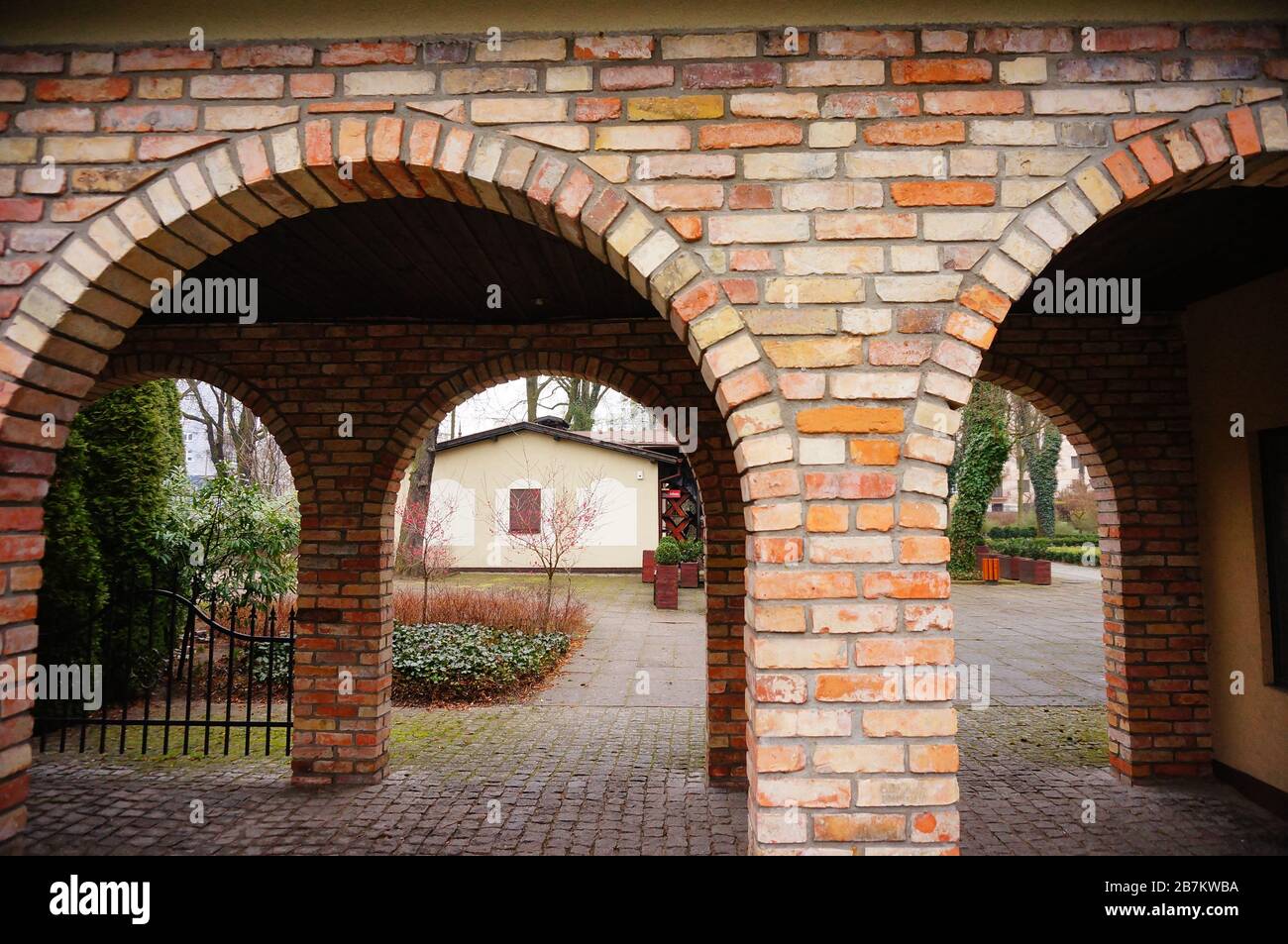 Cobblestone building with an outdoor corridor with arches Stock Photo ...
