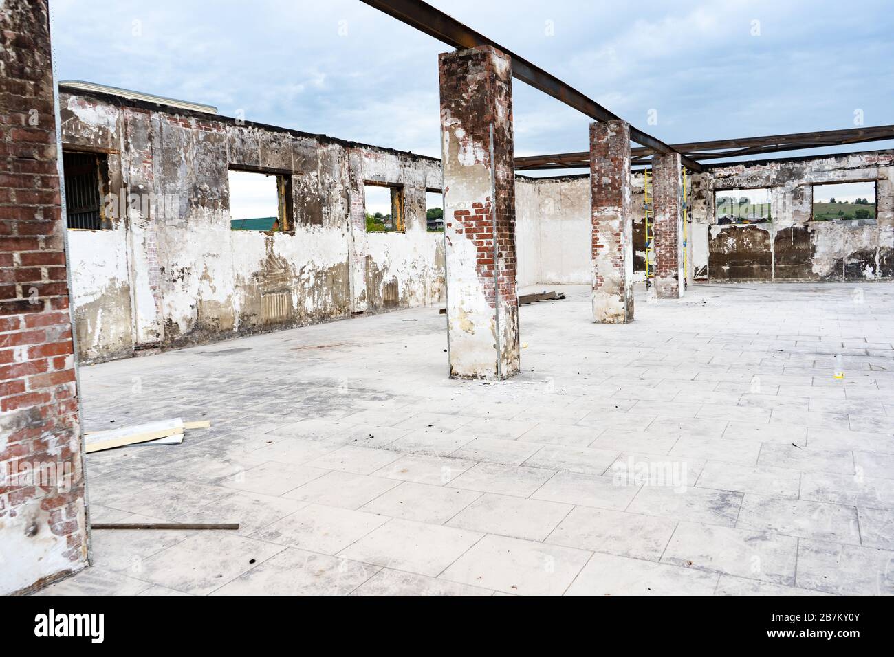 Abandoned warehouse with columns without a roof. Large industrial room ...