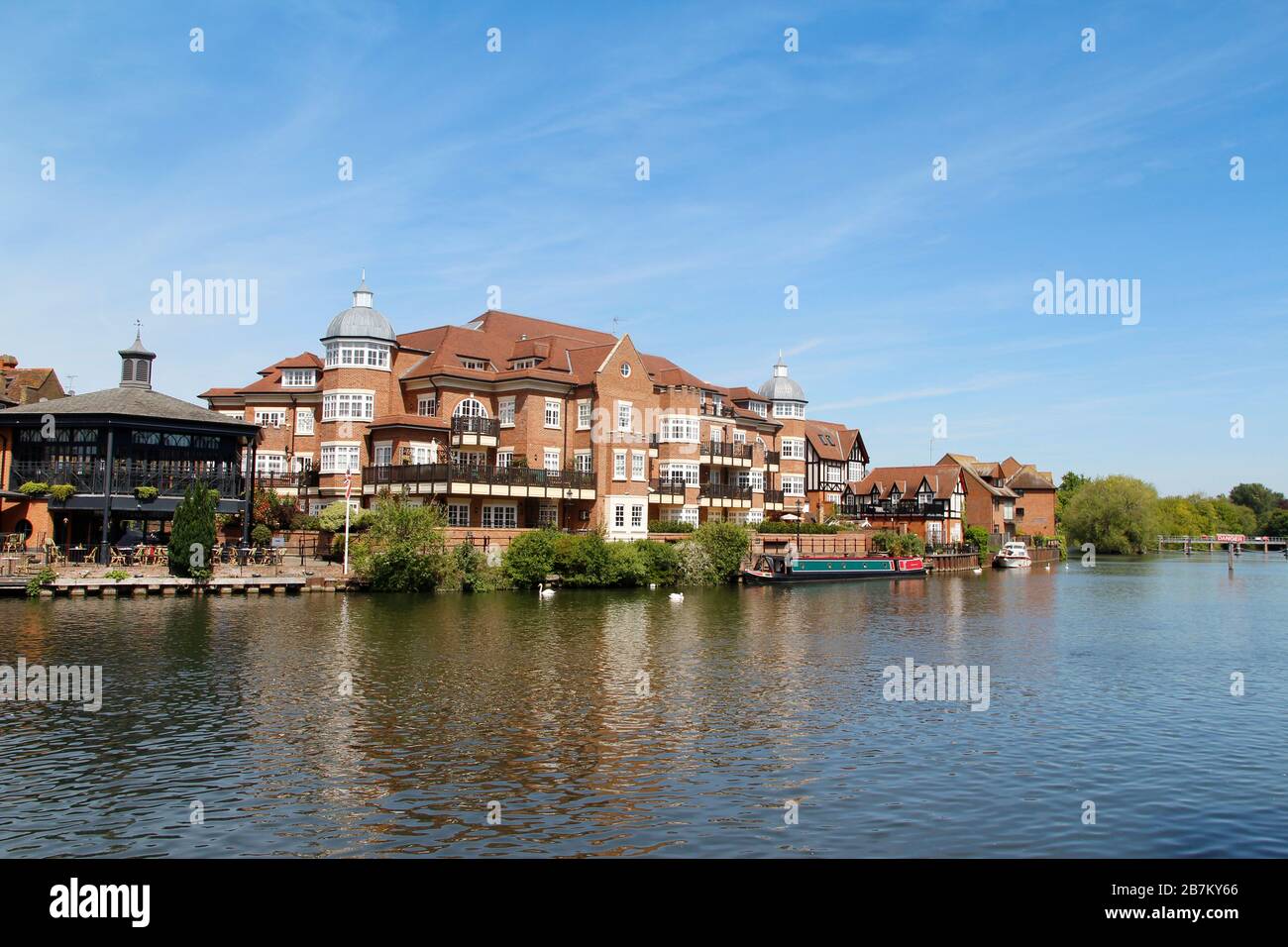 Spring view of Windsor with the apartment houses, swans on the river ...