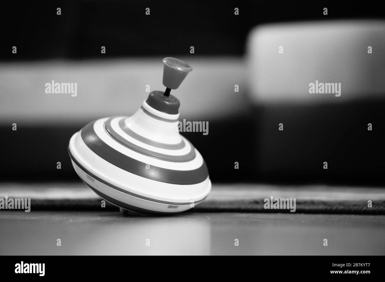Greyscale closeup shot of a spinning top lying on the floor Stock Photo ...
