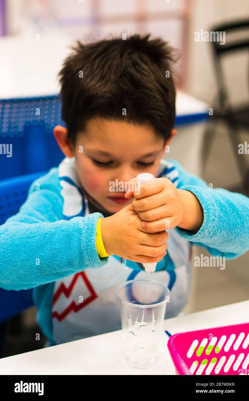 POZNAN, POLAND - Mar 08, 2018: Young boy working on a experiment in a ... POZNAN, POLAND - Mar 08, 2018: Young boy working on a experiment in a ...
