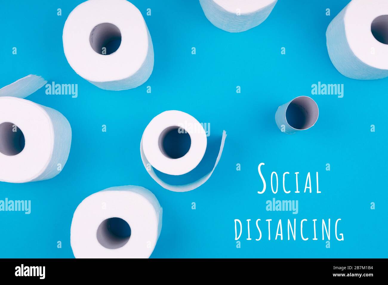 Toilet paper rolls on the bright blue background with Social distancing ...