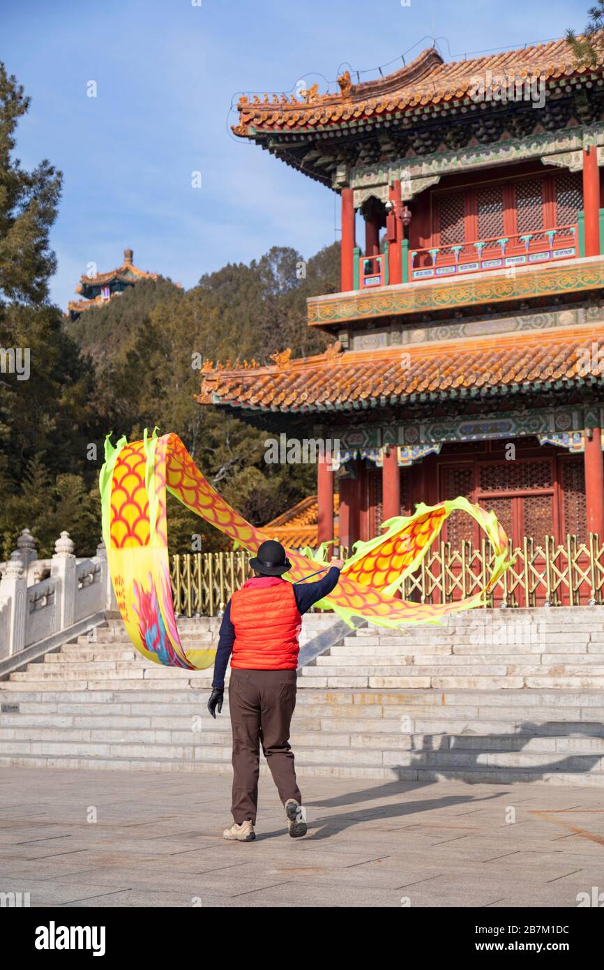 Woman twirling dragon banner in Jingshan Park, Beijing, China Stock ...