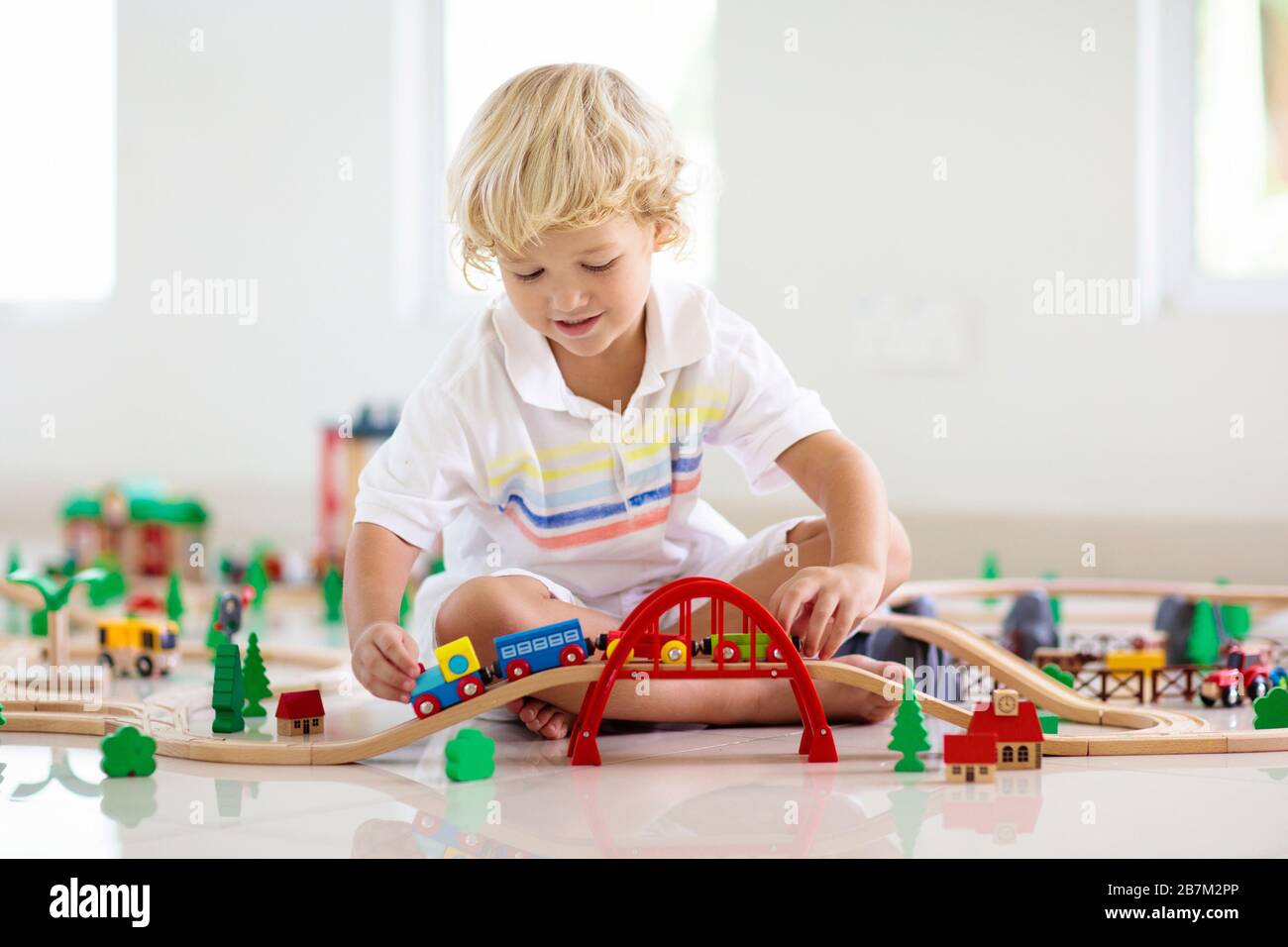 Kids play with wooden railway. Child with toy train. Educational toys ...