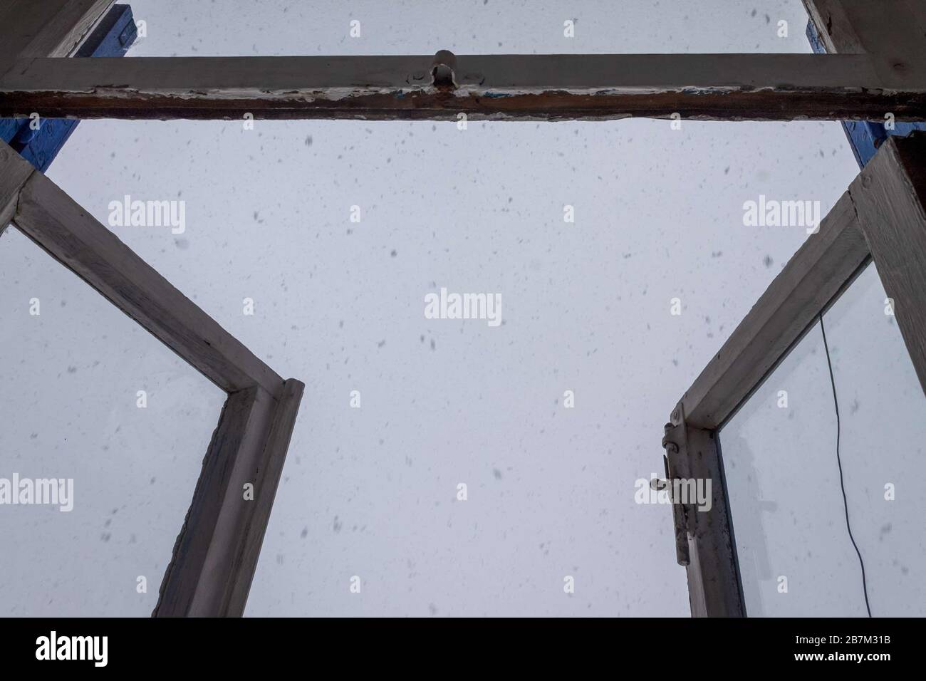an old open window with a crack in the glass and falling snow Stock ...