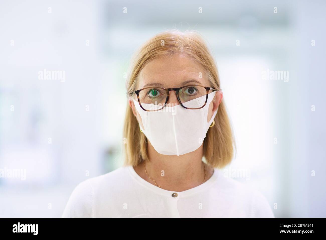 Senior woman wearing face mask during corona virus and flu outbreak ...