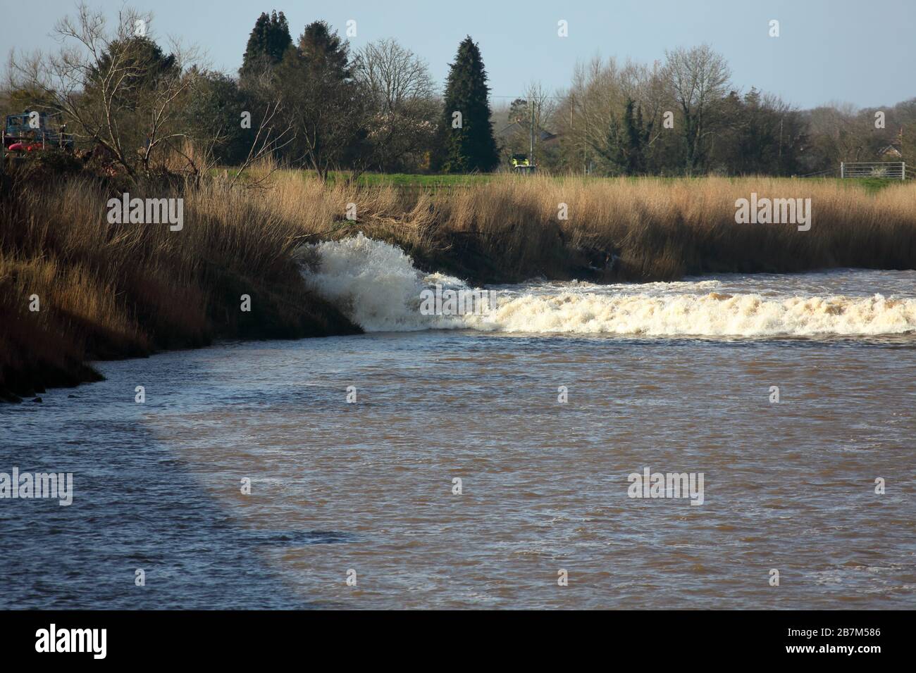 The Severn river Bore barrelling along an already swollen water of the ...