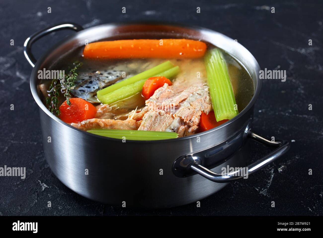 slow-cooked fish broth or soup of salmon, onion, carrot, celery, herbs ...