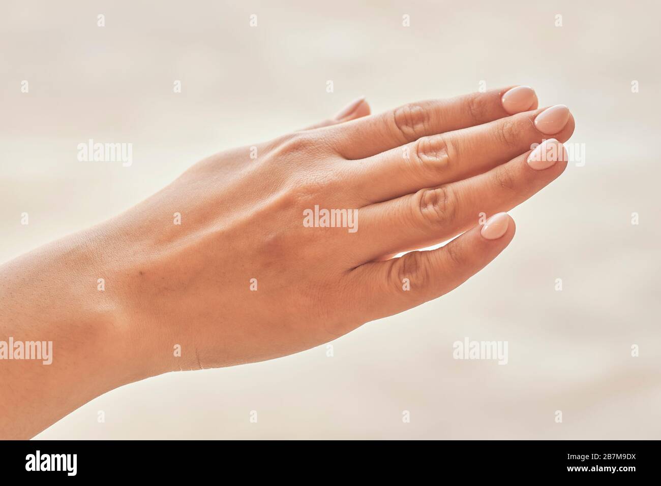An unrecognizable woman arms. Woman showing hands with beautiful light ...