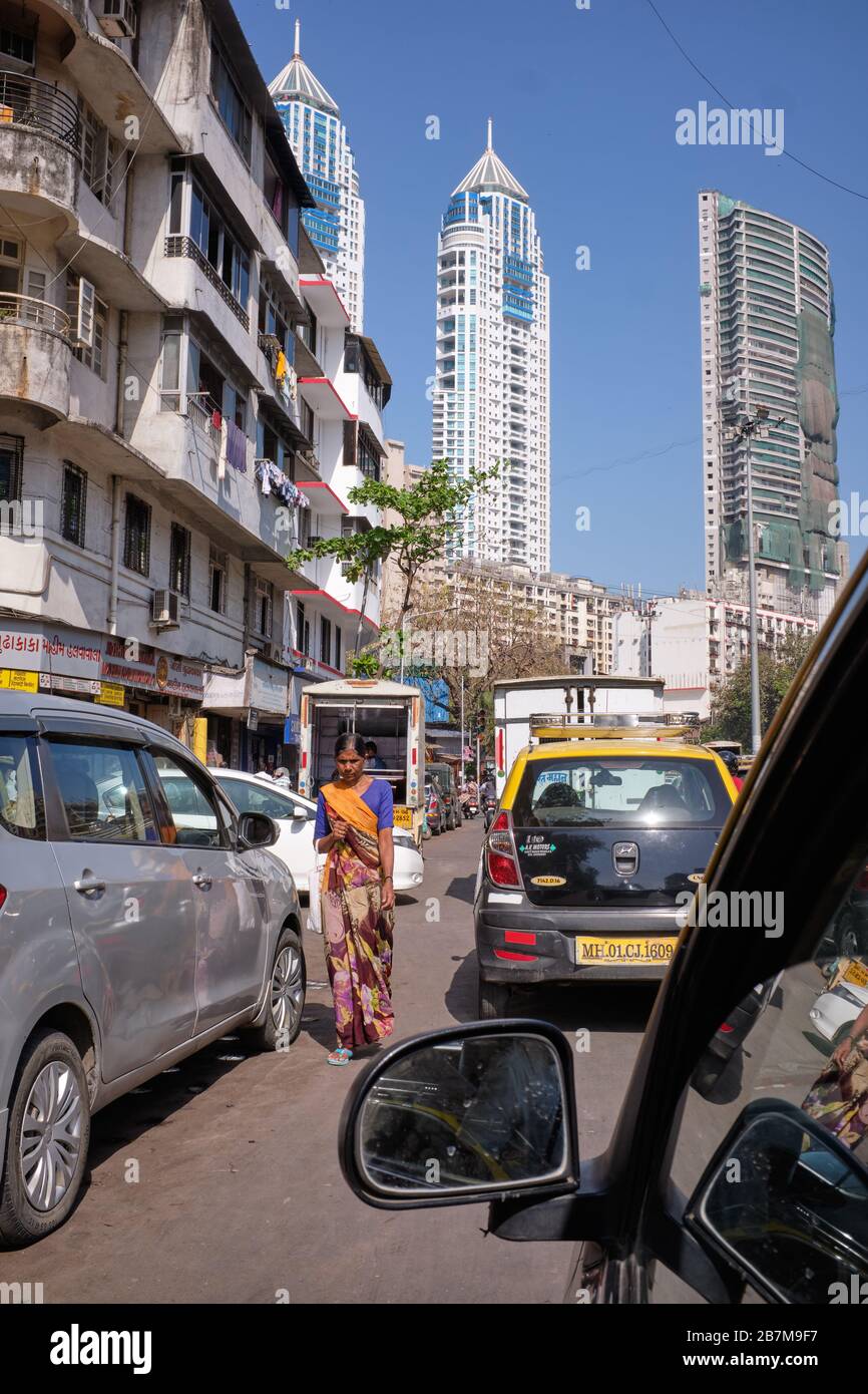 Modern high rise buildings towering over an older building in Central ...