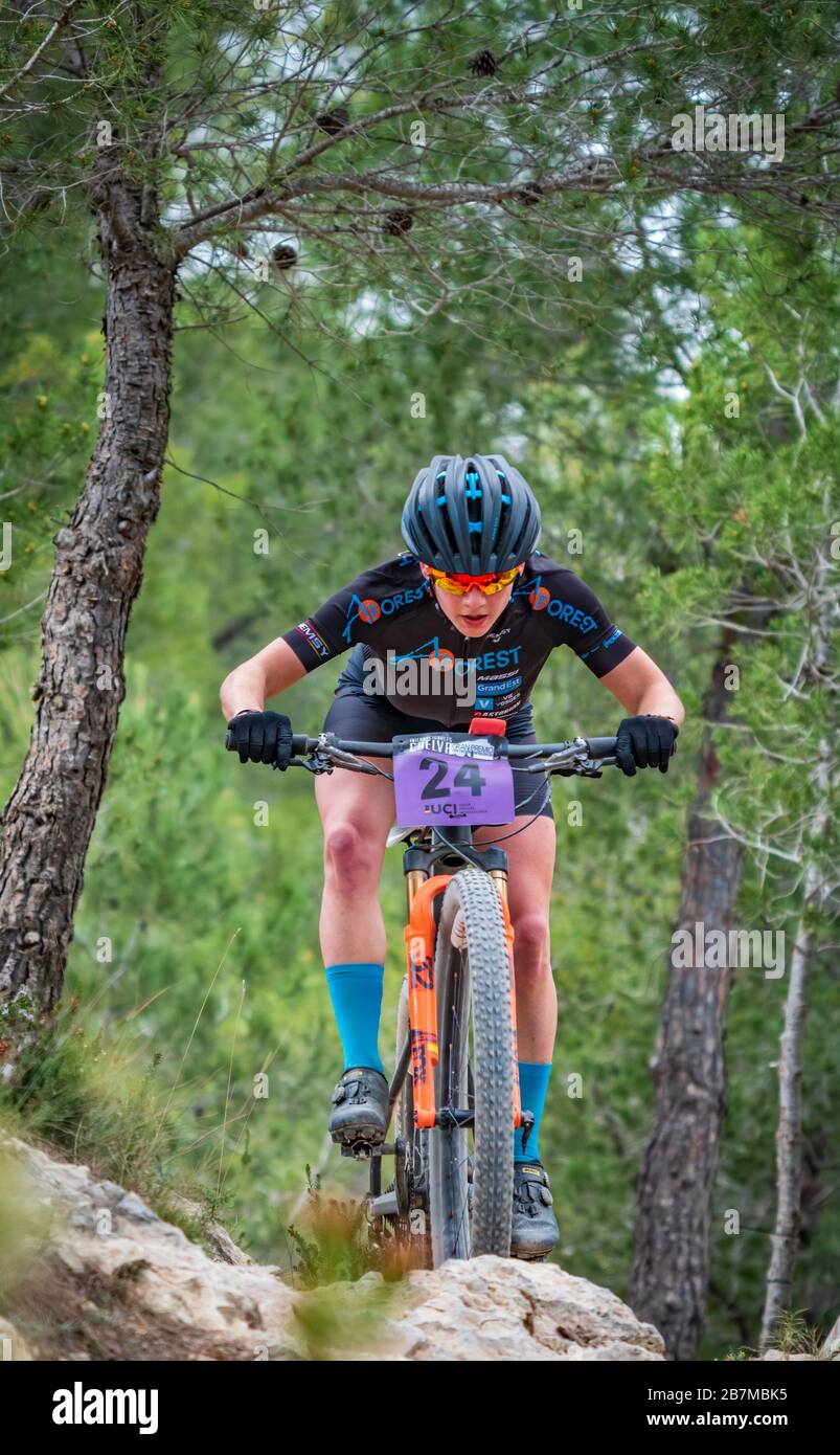 Bouilloux Lea descends behind pine trees in MTB championship Stock ...