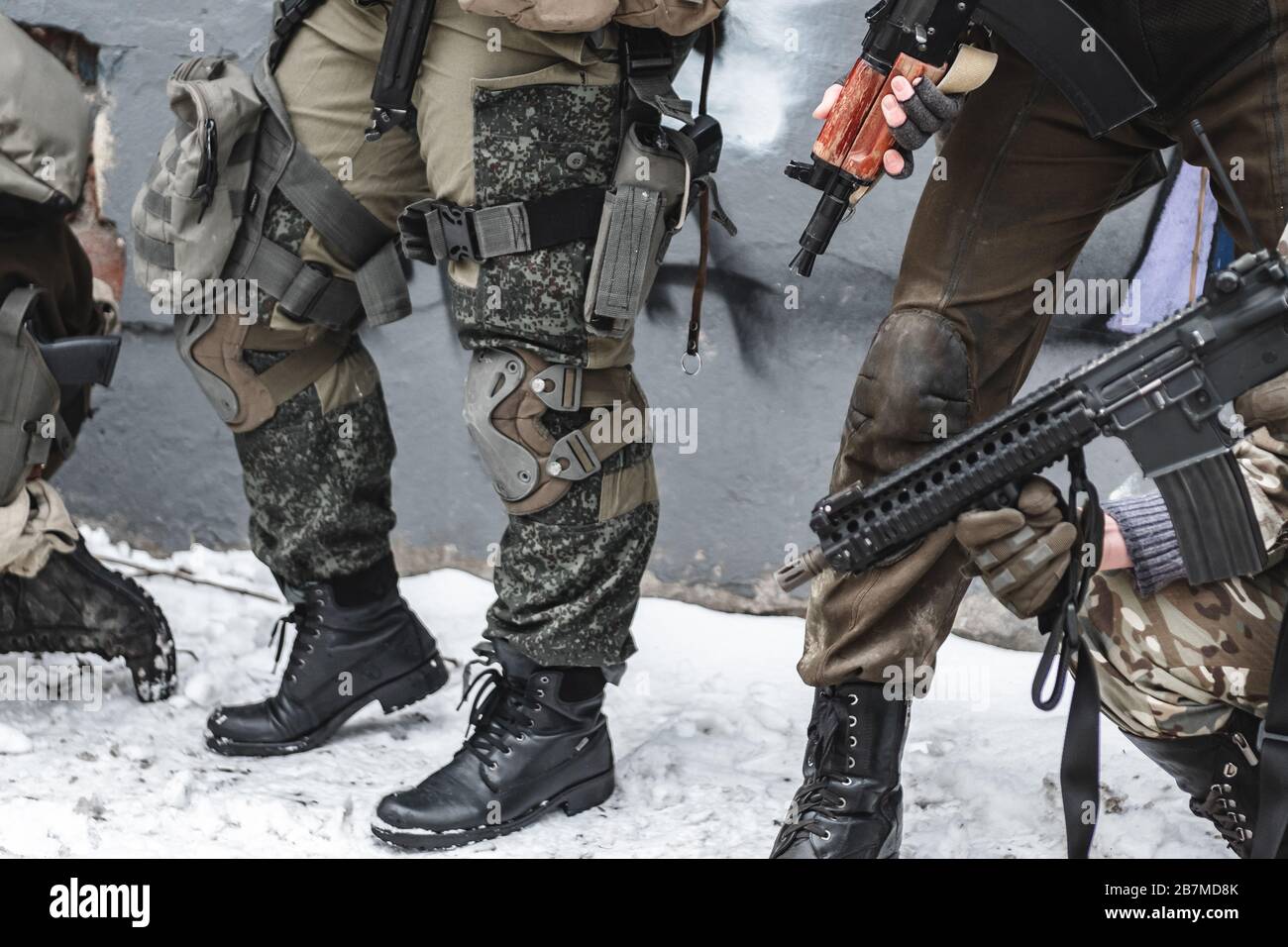 The military with rifles carry out the task in the winter. Close up ...