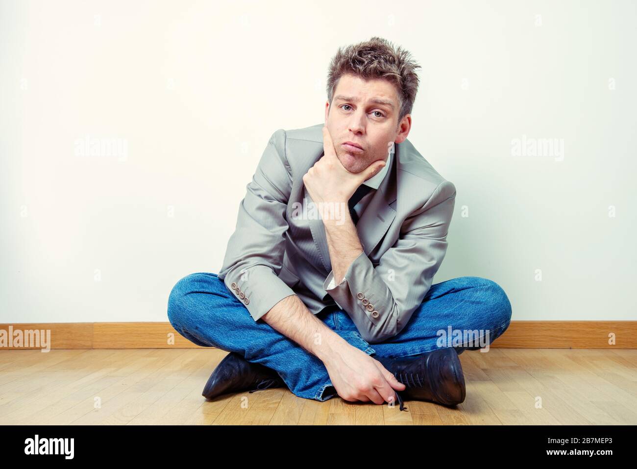 Portrait of a worried or concerned man or freelancer worker sitting ...