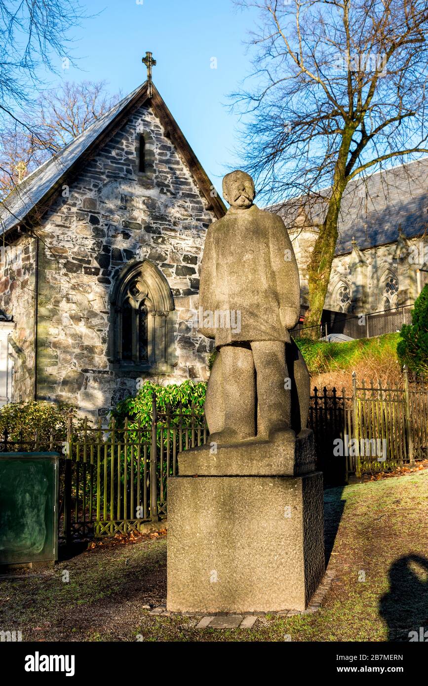 A statue of Norwegian writer Arne Gaborg behind Stavanger cathedral in ...