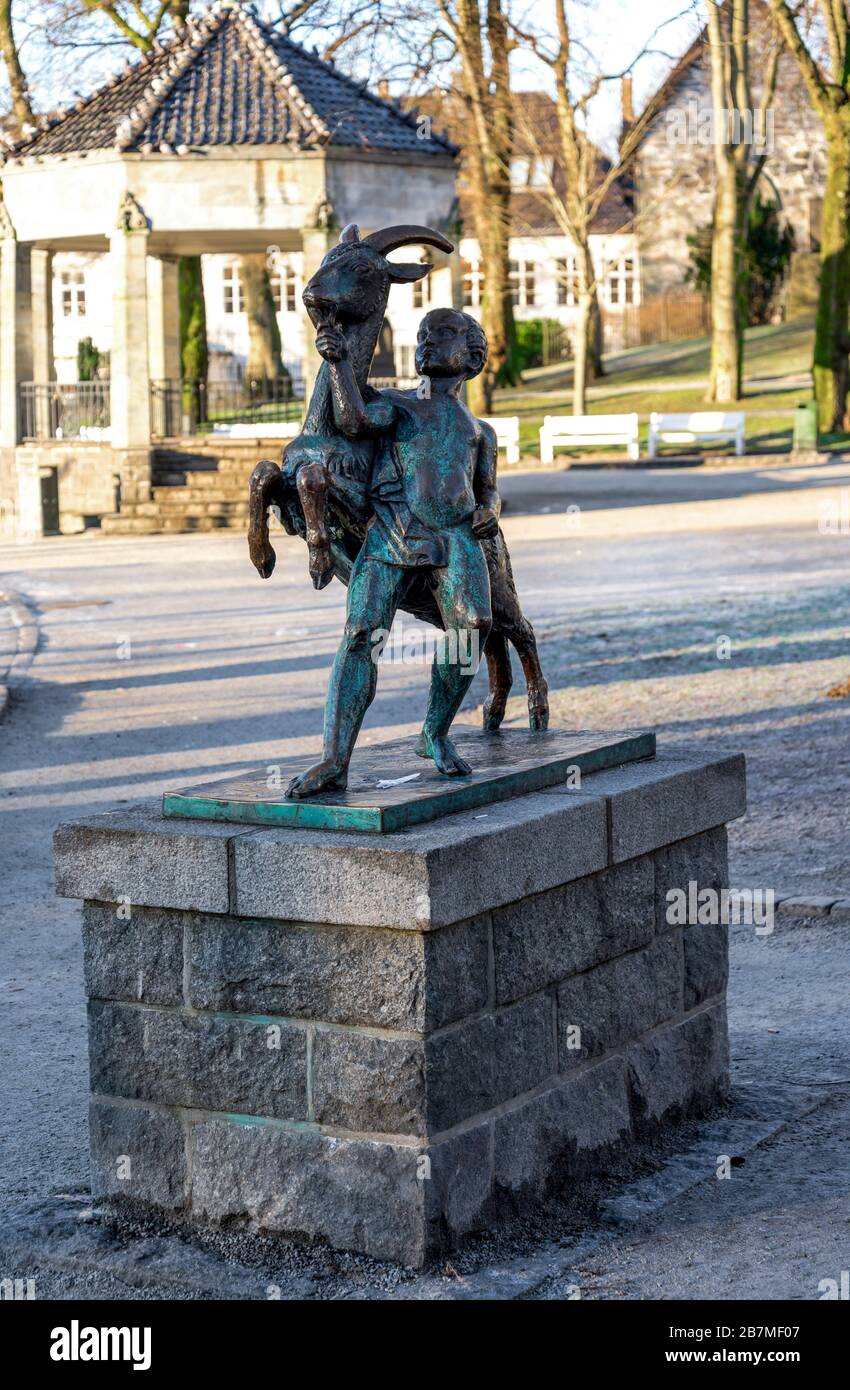 A small bronze statue of a boy with a goat in Stavanger city park ...