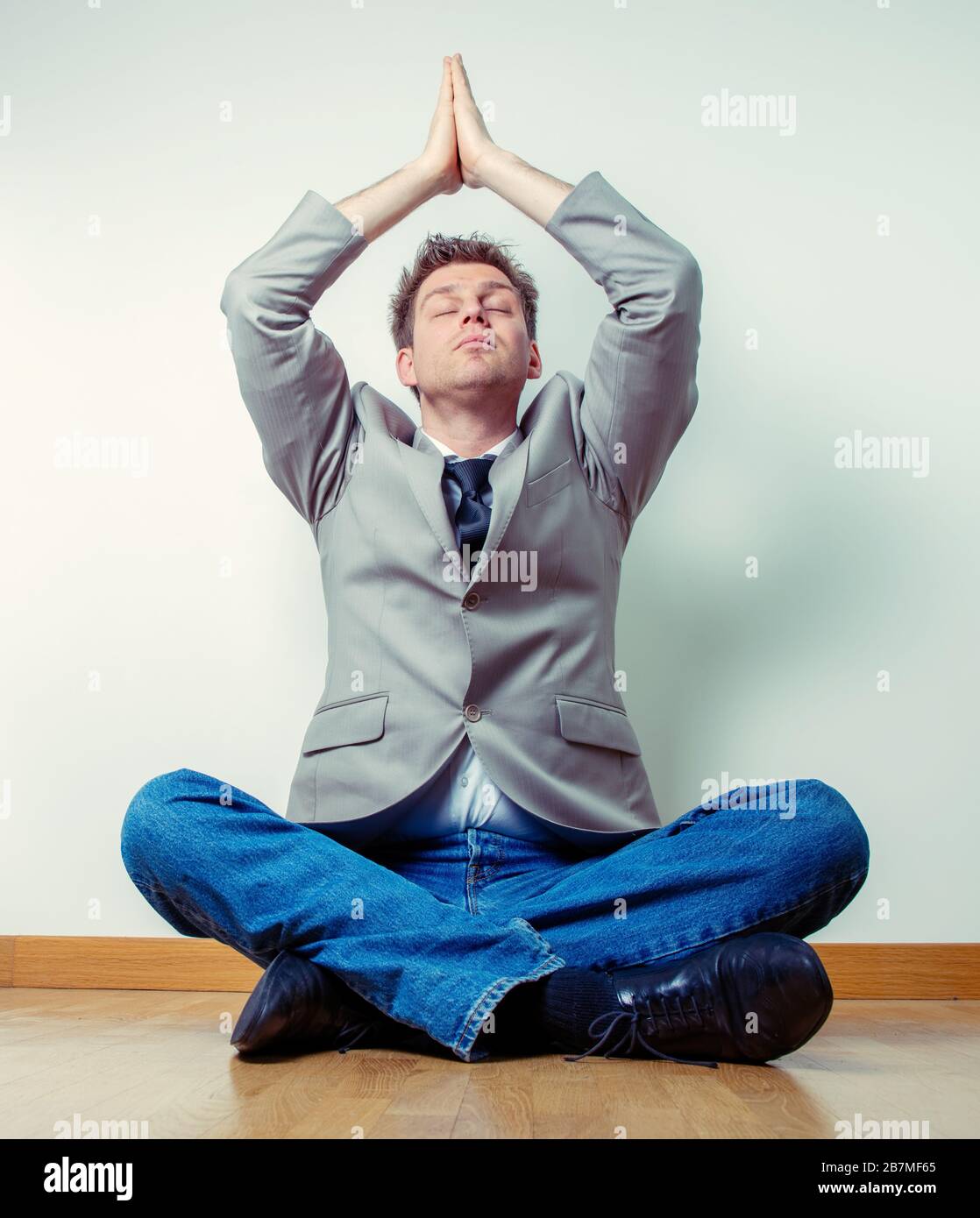 Portrait of freelance worker doing relaxation exercises at home sitting ...