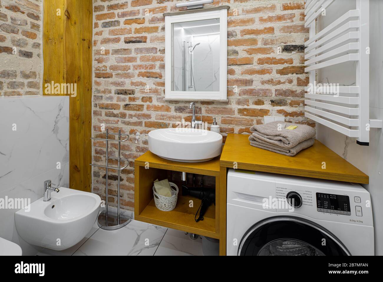 Modern contemporary loft interior of bathroom. Brick wall. Washing ...
