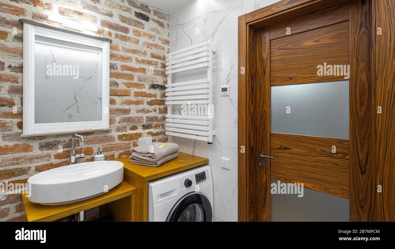 Modern contemporary loft interior of bathroom. Brick wall. Washing ...