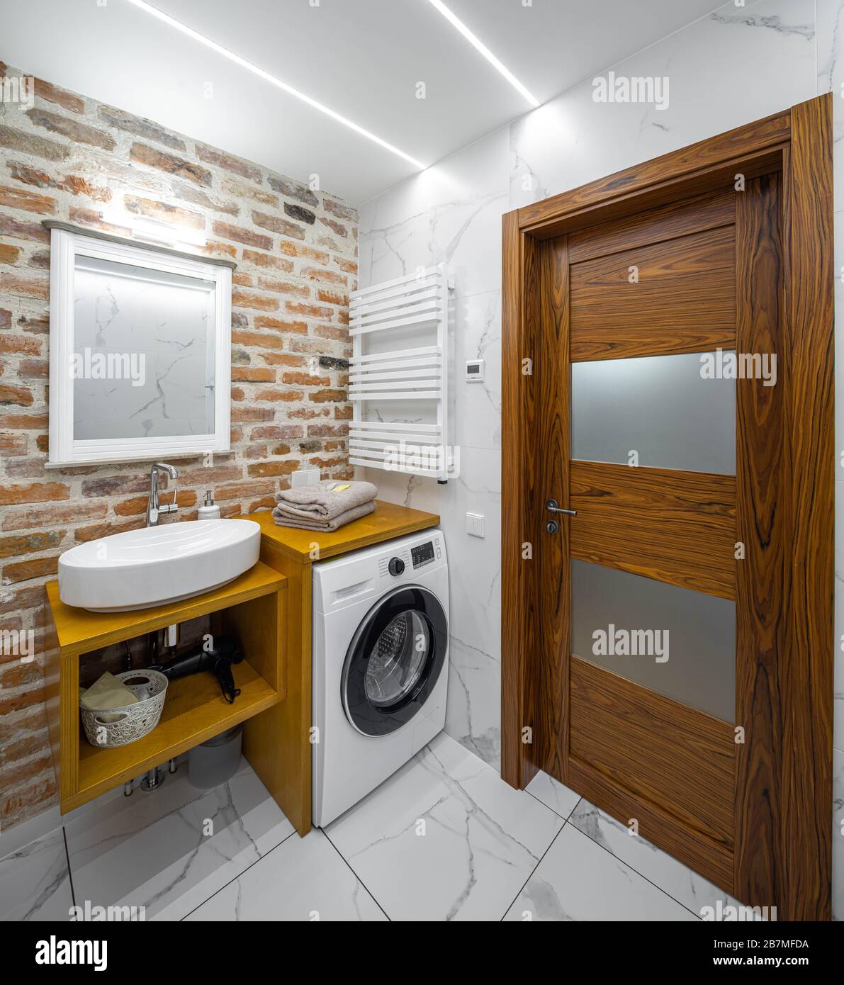 Modern contemporary loft interior of bathroom. Brick wall. Washing ...