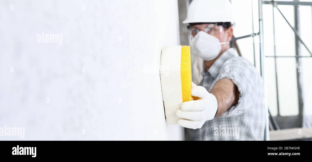 man builder using a sponge on wall professional construction worker ...