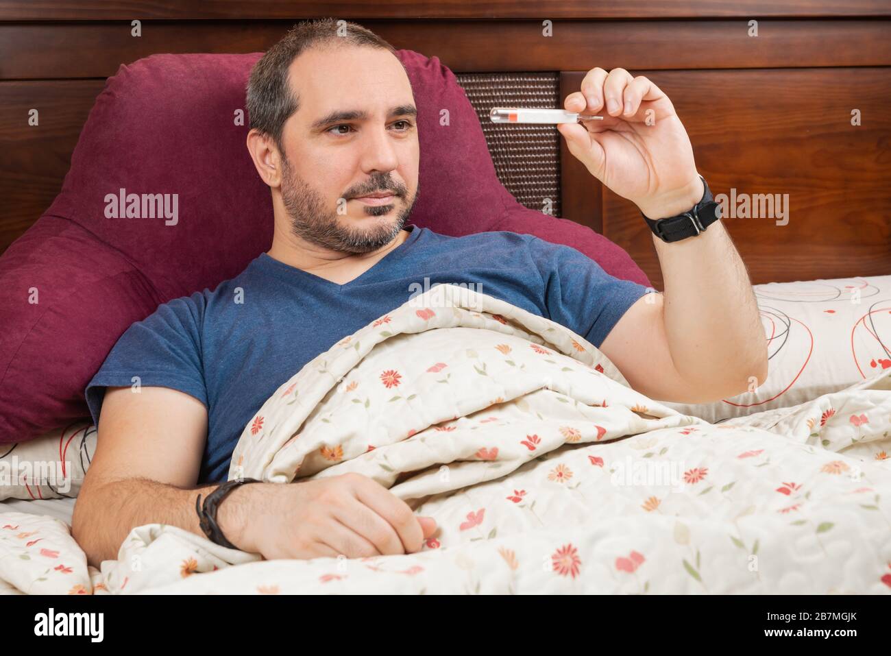 Sick person with thermometer in bed hi-res stock photography and images ...